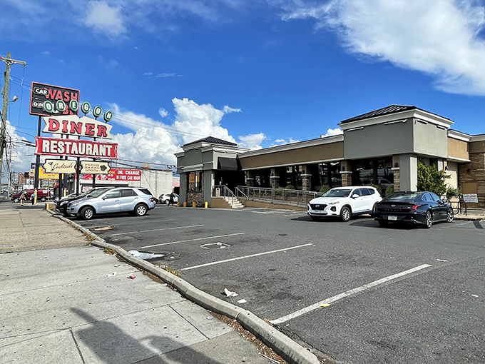 The iconic Oregon Diner sign stands proud against the Philly sky, a beacon of breakfast hope for hungry souls seeking salvation in syrup.