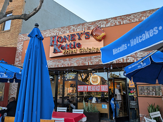 The golden glow of Honey's Kettle beckons from Culver City's streets, promising fried chicken nirvana under those charming string lights.