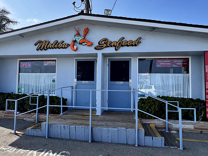 The unassuming white facade of Malibu Seafood, where that iconic red lobster sign has been beckoning seafood lovers off PCH for decades.