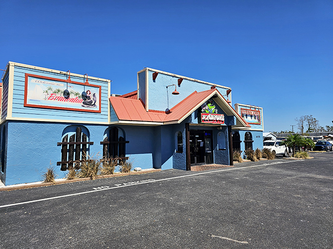 The vibrant turquoise exterior of RJ Gator's stands out like a peacock at a chicken convention, promising Florida flavors with every shade of blue.
