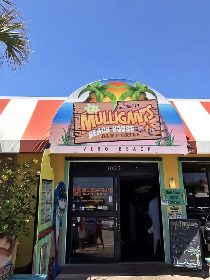 The vibrant entrance to Mulligan's Beach House beckons with tropical flair &ndash; like a cheerful postcard come to life under that perfect Florida sky.