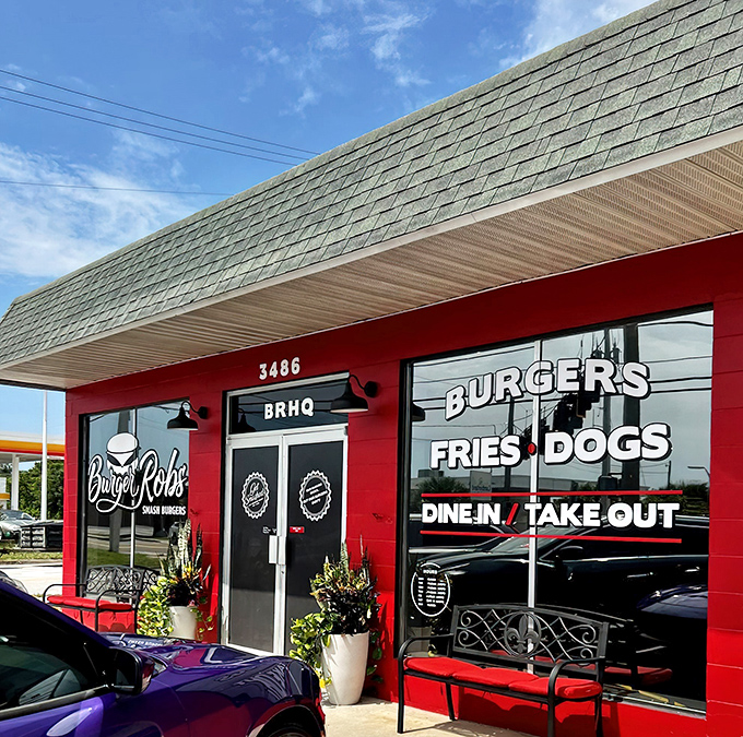 The bright red exterior of BurgerRobs stands like a beacon of burger hope in Titusville, promising simple pleasures: burgers, fries, and dogs done right.