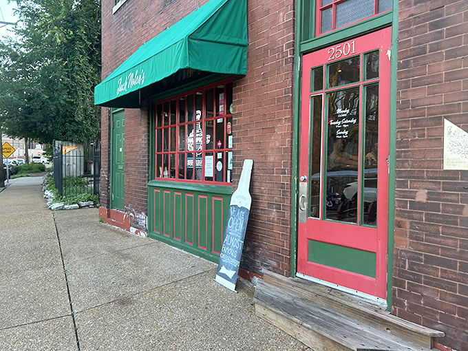 The unassuming exterior of Jack Nolen's, with its classic brick facade and green awning, proves that burger greatness often hides in plain sight.