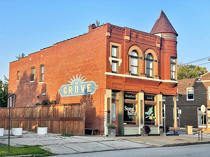 The historic brick building with its distinctive turret stands as a beacon for breakfast lovers in The Grove neighborhood.