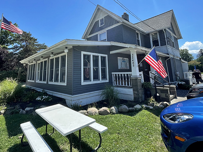 Home sweet lakeside home! Jake's On Lake's charming blue exterior with American flags fluttering in the breeze promises comfort food that's anything but ordinary.