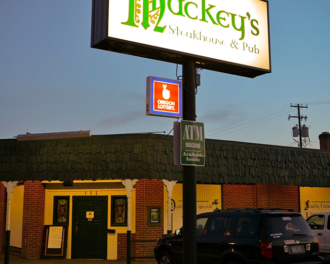 The unassuming exterior of Mackey's beckons like a lighthouse for hungry travelers. That glowing sign promises steak salvation in Ontario's quieter corner. 
