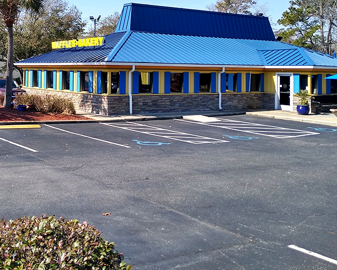 The sunshine-yellow exterior with that unmistakable blue roof isn't just a building&mdash;it's a morning beacon of breakfast possibilities waiting to happen.