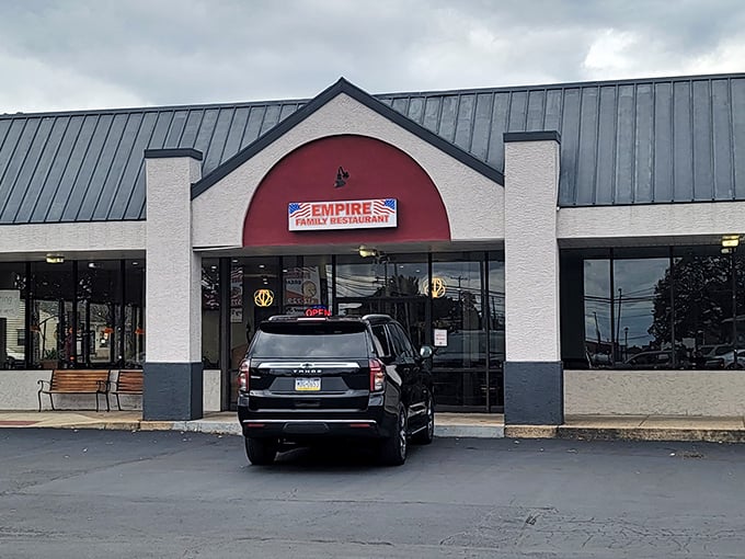 The iconic red arch of Empire Family Restaurant beckons hungry travelers like a culinary lighthouse in a sea of chain restaurants.