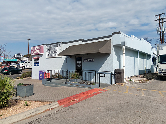 The unassuming exterior of Blue Bonnet Cafe stands like a beacon of hope for hungry travelers. That "Pie Happy Hour" sign is basically a bat signal for dessert enthusiasts.