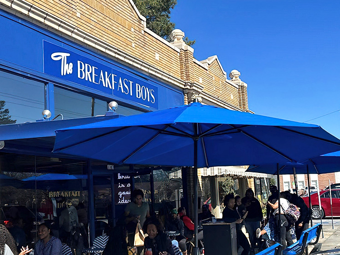 The bright blue exterior of The Breakfast Boys stands out like a culinary beacon in College Park, promising morning delights under those matching umbrellas.