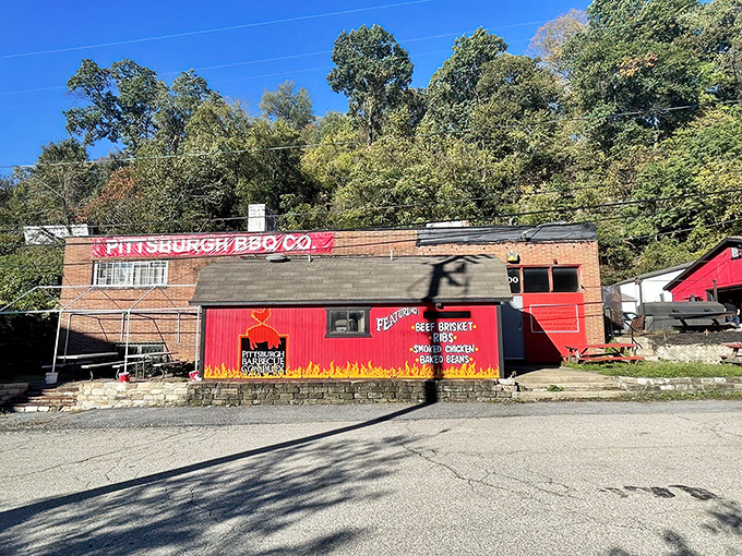 The bright red exterior of Pittsburgh BBQ Co. stands out like a beacon of smoky promise against Pennsylvania's green hillside.