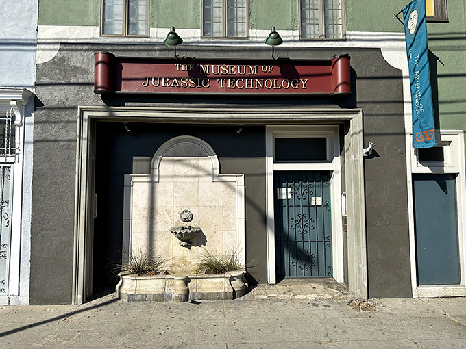 The unassuming facade of wonder &ndash; where curiosity lives behind a mint-green exterior and burgundy sign that promises the unexpected.