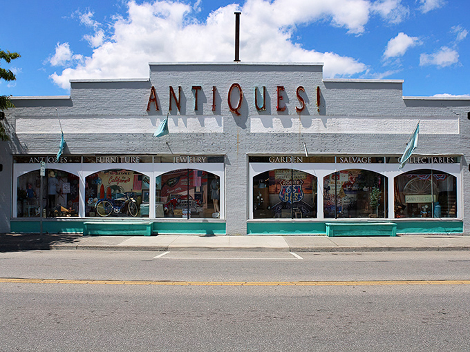 The iconic white facade of Charlotte's Web Antique Mall beckons with its bold "ANTIQUES!" declaration &ndash; like a siren song for treasure hunters everywhere.