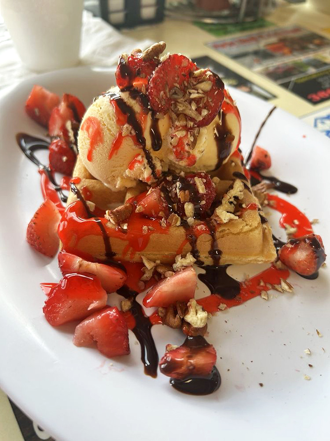 Dessert masquerading as breakfast? This waffle masterpiece with ice cream, strawberries, and chocolate drizzle makes a compelling argument for starting sweet.