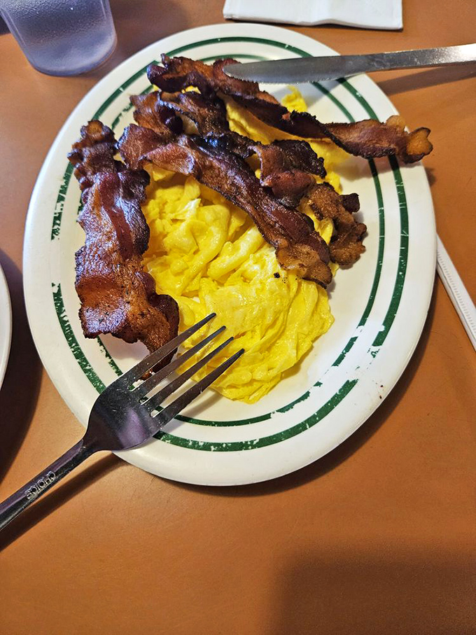 Bacon that's achieved crispy perfection alongside fluffy scrambled eggs. Simple? Yes. Ordinary? Not even close. This is breakfast as it should be.