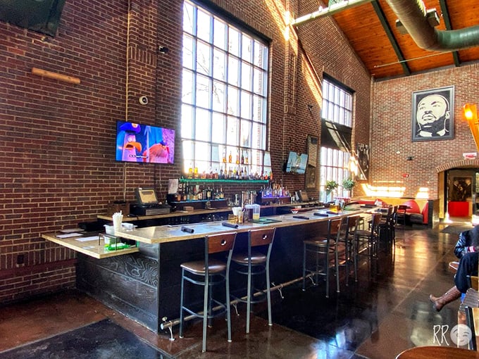 The bar stands ready for serious business, where exposed brick and warm lighting create the perfect backdrop for storytelling and sipping.
