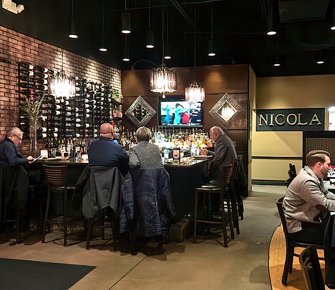 The bar at Nicola's isn't just where drinks are served—it's where friendships are forged and dinner plans are forgotten.