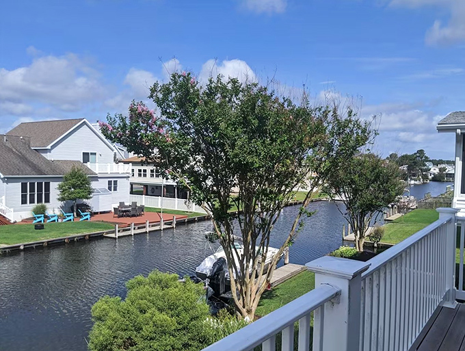 Perfectly manicured lawns meet wooden bulkheads where residents can fish, kayak, or simply watch herons hunt for breakfast in their aquatic backyard.