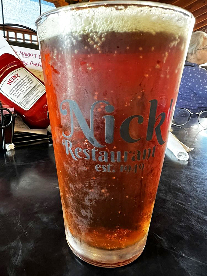 A frosty pint glass emblazoned with the Nick's logo – because great food deserves equally great beverages to wash it down.