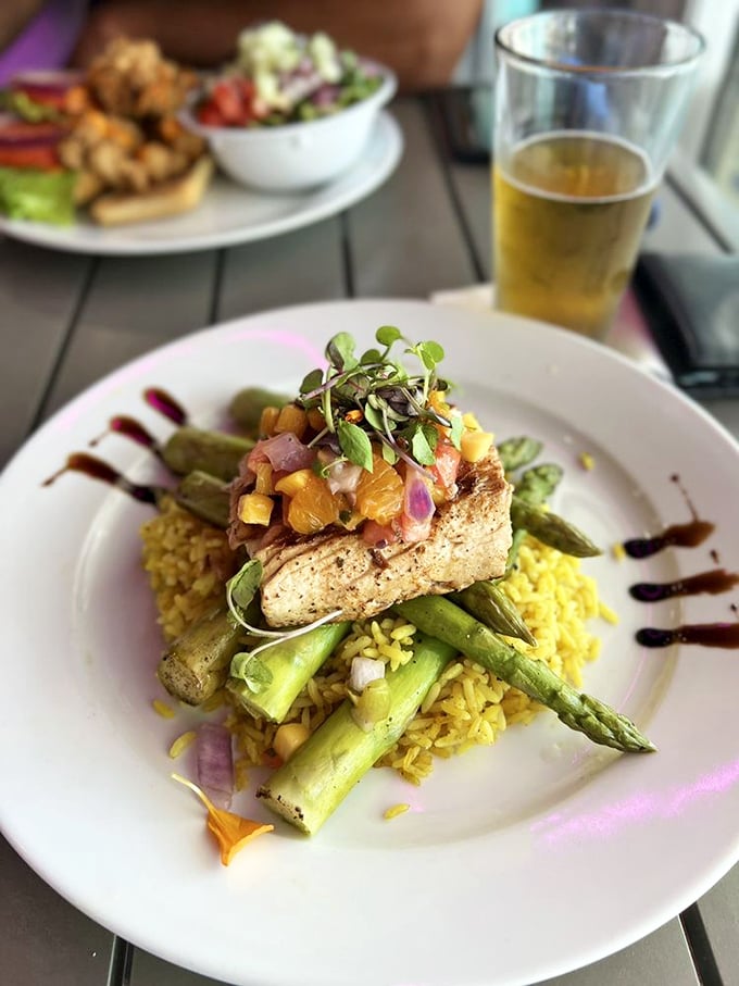 A culinary masterpiece of blackened fish atop saffron rice and asparagus. The tropical salsa crown adds a burst of sunshine to every bite.
