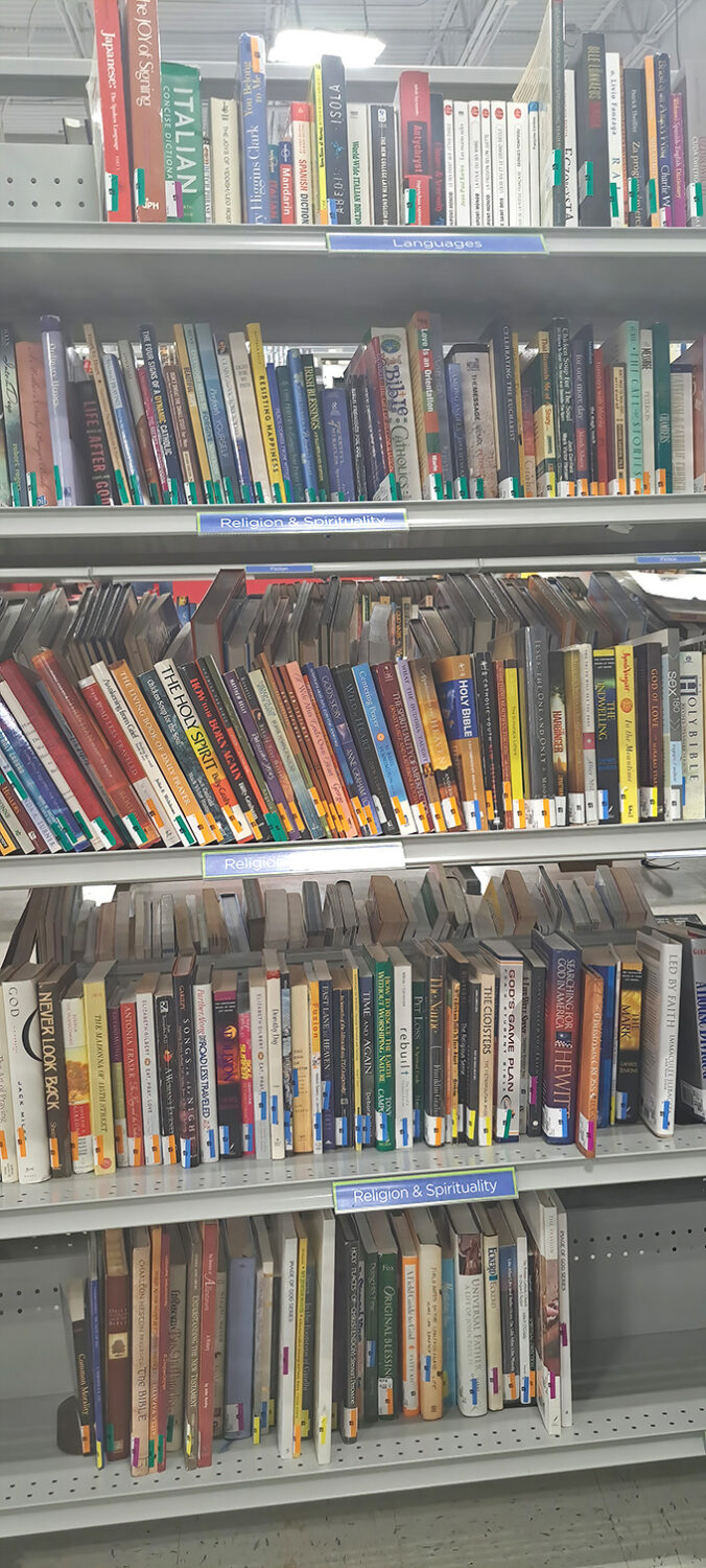 The book section offers literary adventures organized by genre. Somewhere in these stacks is the paperback that will change your life for just $1.99.