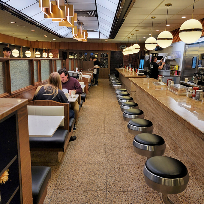 Classic diner counter seating meets modern design. Those globe lights cast the perfect glow for both early morning coffee and late-night pie contemplation.