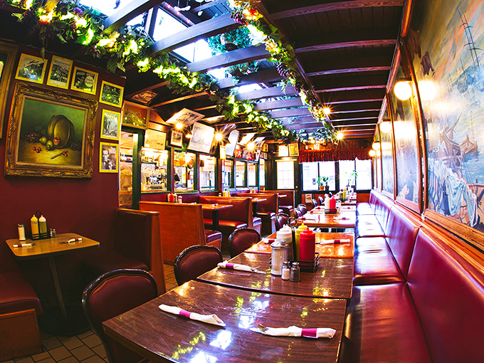 Holiday lights twinkle year-round above red vinyl booths, creating the kind of warm, timeless atmosphere that makes strangers into friends.
