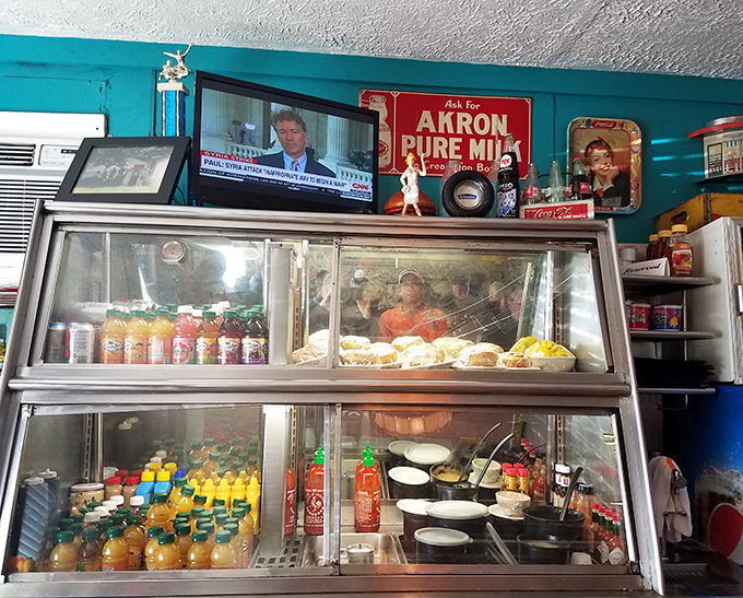 Behind the counter, a treasure trove of beverages and homemade delights await. That vintage Akron Pure Milk sign is a nod to local pride.