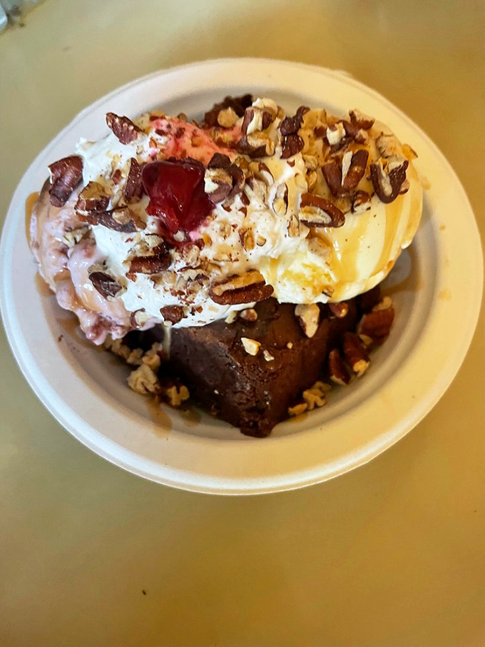 This isn't just a brownie sundae&mdash;it's architecture. The pecans add texture while the whipped cream crowns this temple of indulgence.