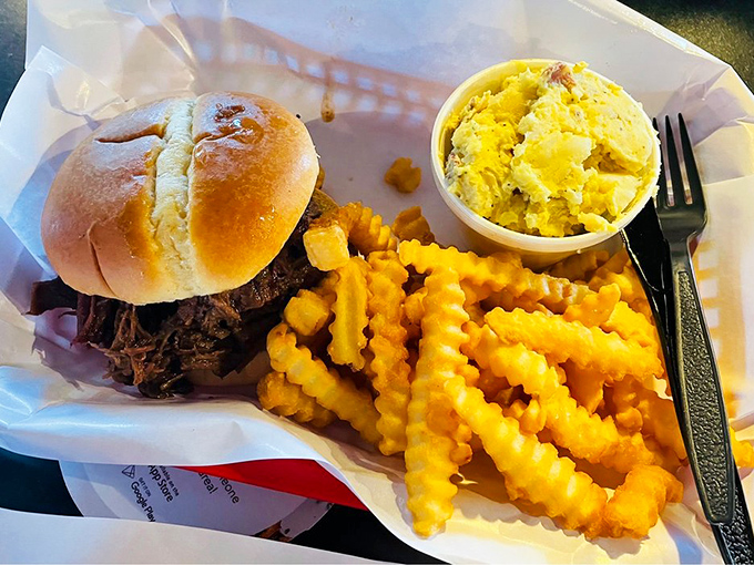 The pulled pork sandwich: meat so tender it surrendered to smoke hours ago, piled high on a bun that's merely transportation to flavor town.