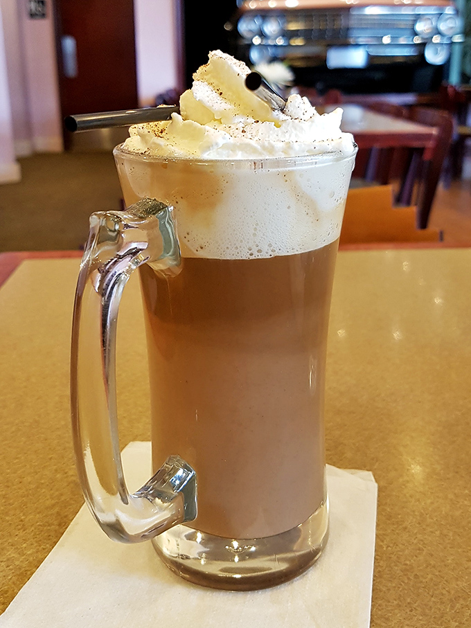 This isn't just coffee, it's a morning miracle in a mug, topped with a cloud of whipped cream that's begging to give you a mustache.