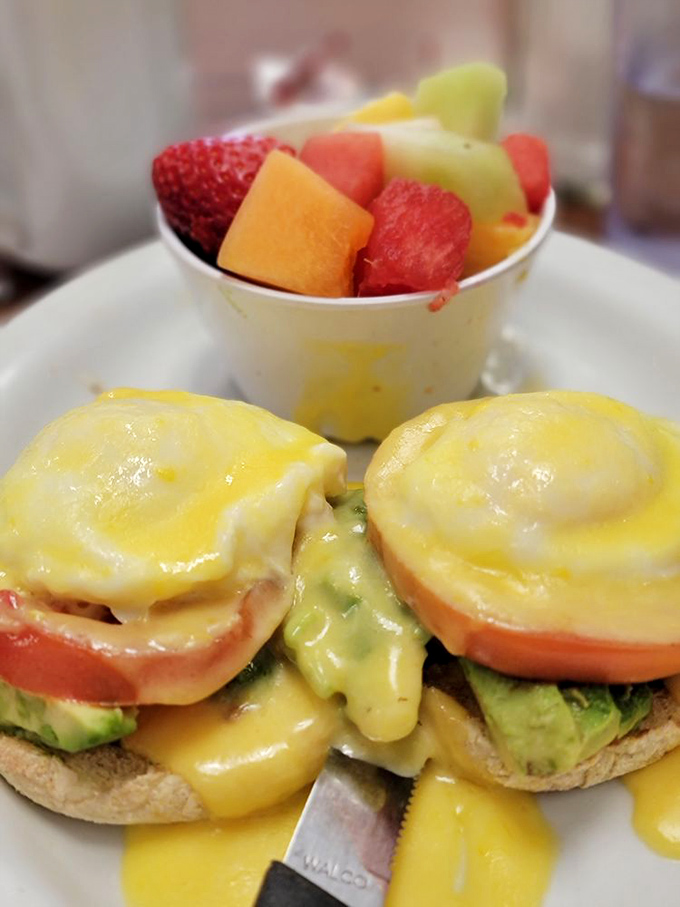 California Benedict with avocado&mdash;where East Coast tradition meets West Coast innovation in a hollandaise-draped masterpiece that defies breakfast boundaries.
