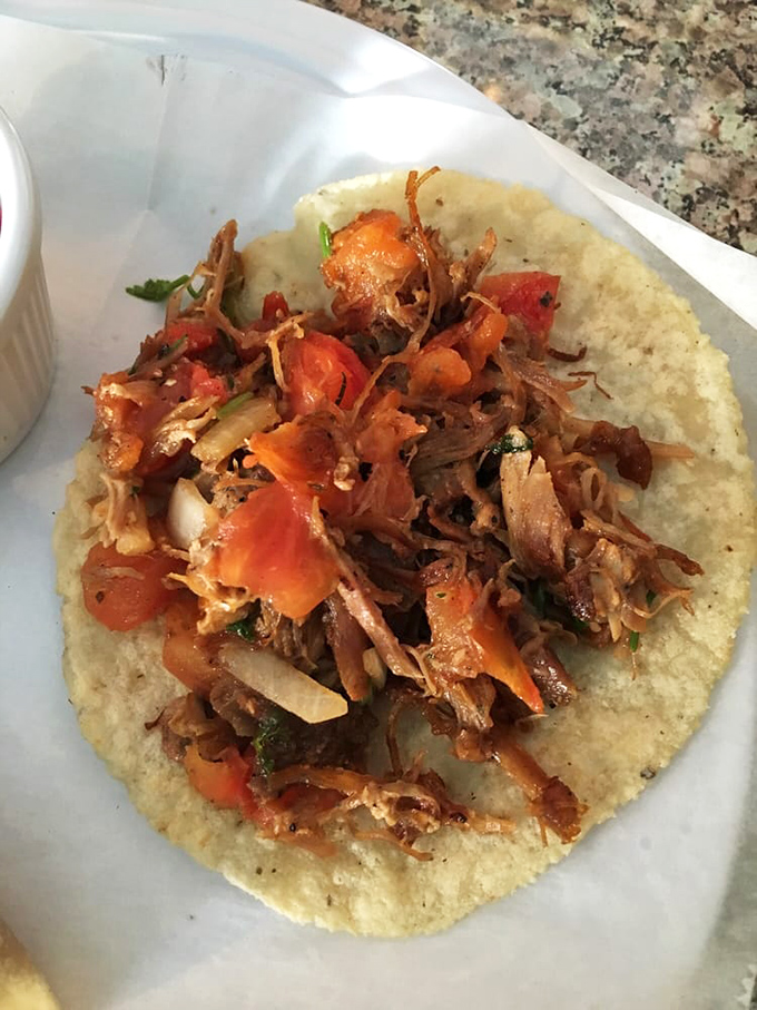 Carnitas tacos topped with fresh pico&mdash;the kind that make you wonder why you ever ate anything else.