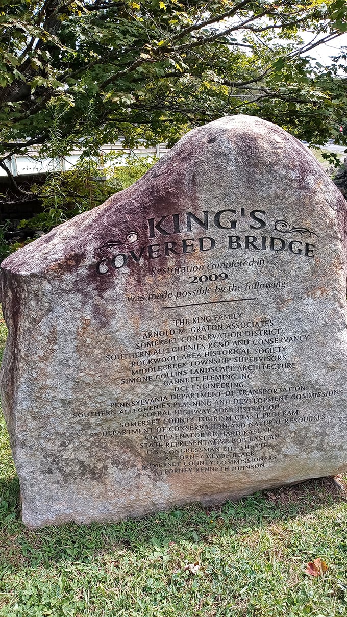 A stone marker tells the bridge's restoration story—because even historic landmarks sometimes need a little help from their friends.