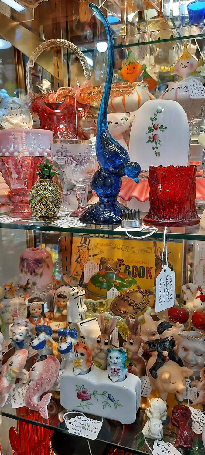 A kaleidoscope of collectible figurines that would make your grandmother squeal with delight. Blue swans meet porcelain memories in this glass menagerie.