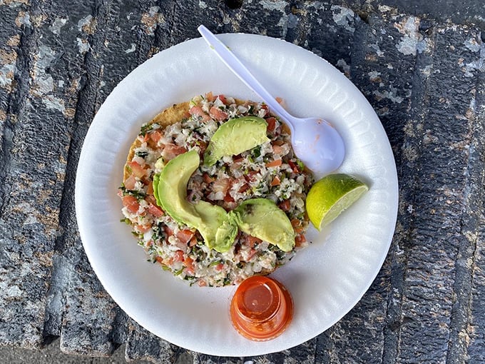 Nature's perfect partnership: creamy avocado slices crown this mountain of diced seafood on a crisp tostada. Simple ingredients, extraordinary results.