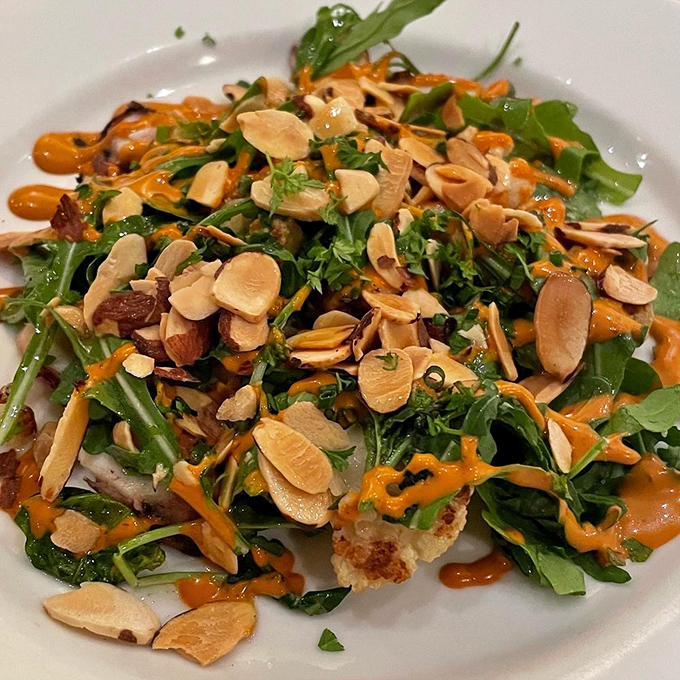 A salad that's having more fun than most entrees. Those toasted almonds and vibrant dressing turn greens into something worth celebrating.