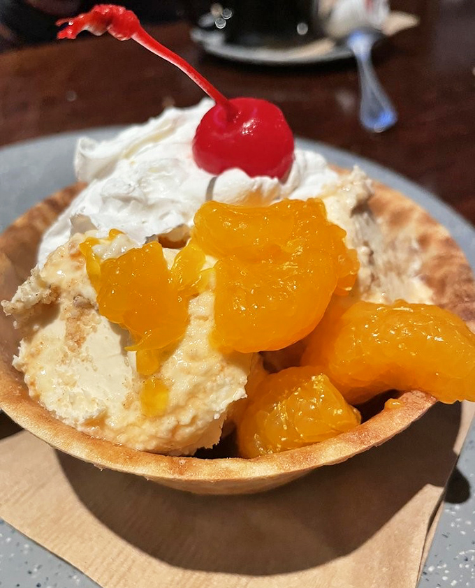 Dessert that hits all the right notes: creamy ice cream, tangy mandarin oranges, and that essential maraschino cherry on top.