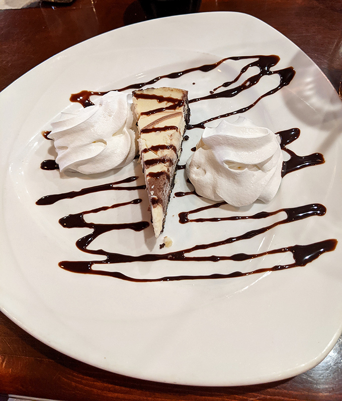 Cheesecake artfully drizzled with chocolate and flanked by whipped cream&mdash;because saving room for dessert isn't just suggested, it's practically mandatory.
