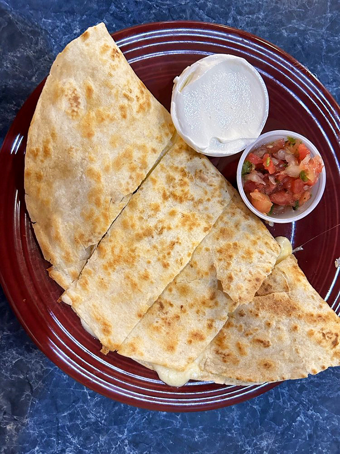 This burrito didn't come to play. Packed with fillings and flanked by fresh salsa and sour cream, it's a meal that demands both hands. 