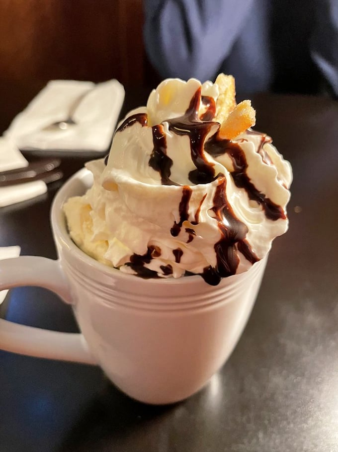 Hot chocolate elevated to an art form. That whipped cream mountain with chocolate lava trails would make Willy Wonka jealous.