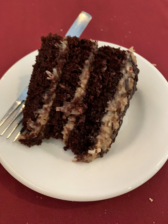 Chocolate cake so rich it should have its own tax bracket, with layers that tell a more compelling story than most Hollywood sequels.