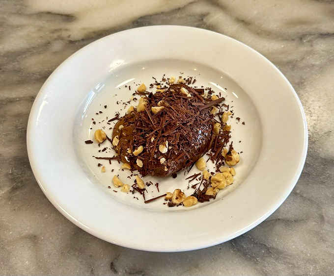 Chocolate mousse that would make Marcel Proust forget all about his madeleines. Velvety, rich, and garnished with chocolate shavings and nuts for textural contrast.