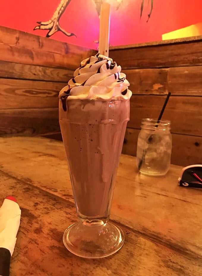This chocolate milkshake isn't just a drink&mdash;it's dessert architecture. The whipped cream tower defies both gravity and willpower.