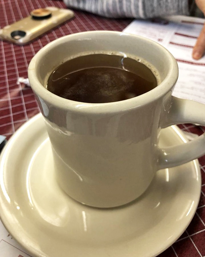 Coffee served in sturdy mugs that feel like handshakes – warm, reliable, and exactly what you need to start a conversation.