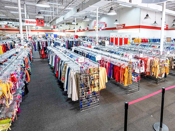 The women's clothing section stretches toward infinity, organized by color to create a rainbow road of fashion possibilities spanning decades and styles.