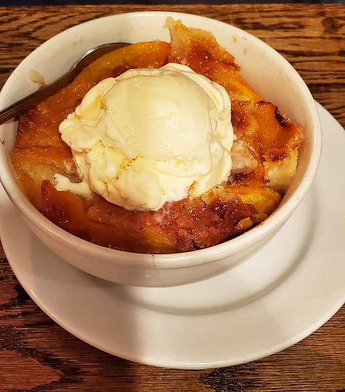 Warm peach cobbler topped with vanilla ice cream - the perfect sweet ending to a smoky feast.