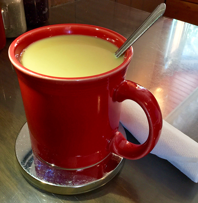 That vibrant red mug isn't just serving coffee&mdash;it's delivering liquid motivation for whatever mountain adventure awaits outside.