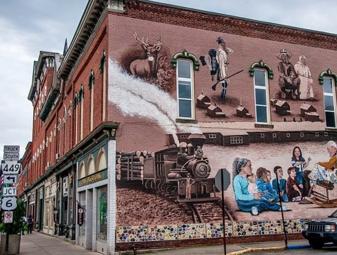 The community mural wraps the town's history around this building corner, telling stories of trains, wildlife, and generations of Coudersport residents.