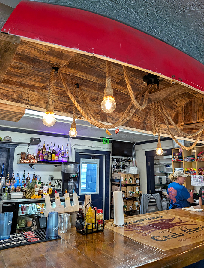 The bar's nautical-rustic charm, with rope lighting and weathered wood, creates the perfect atmosphere for seafood tales and cold beer.